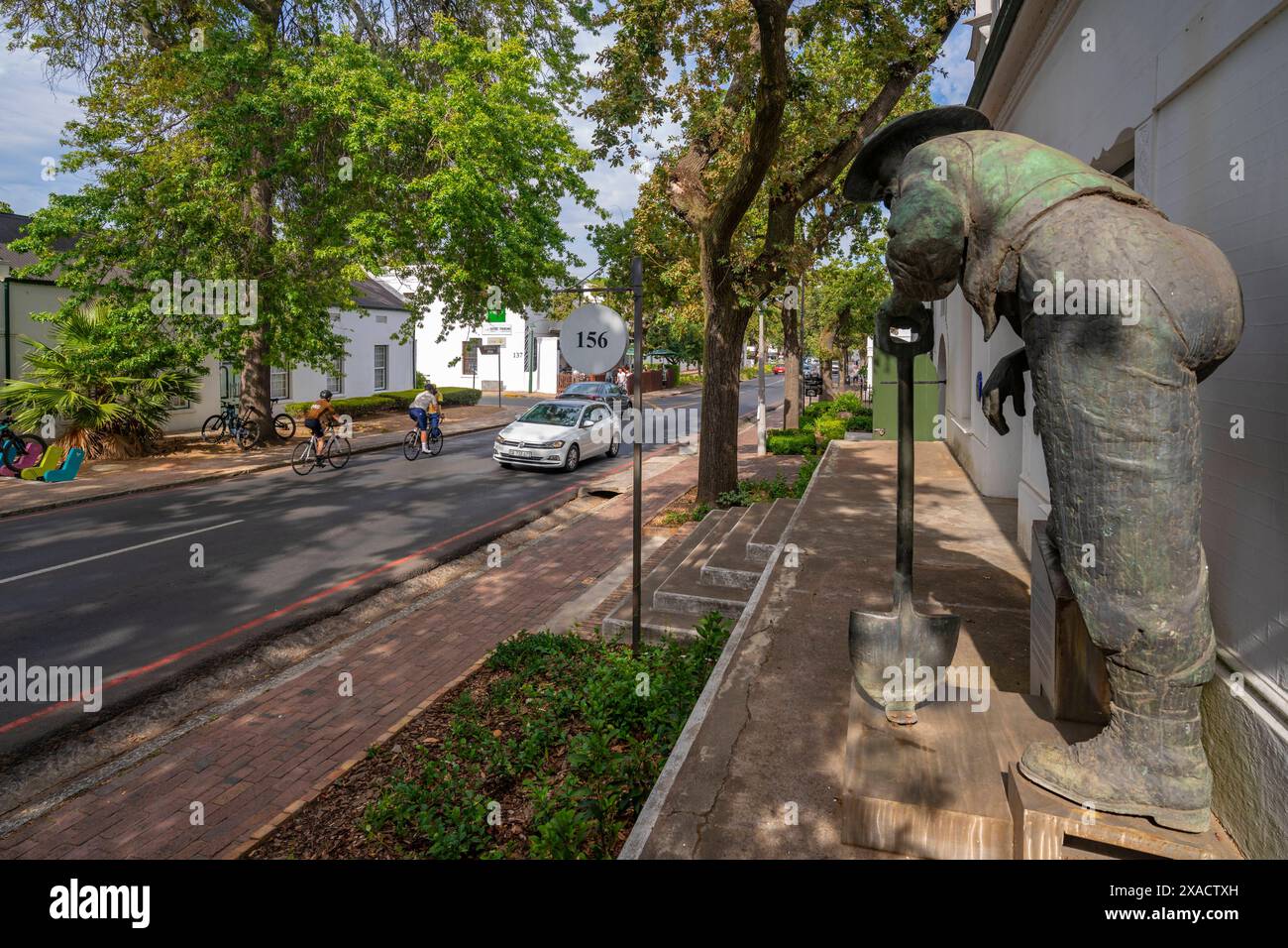 View of Old Mac statue and cyclists in street, Stellenbosch Central ...