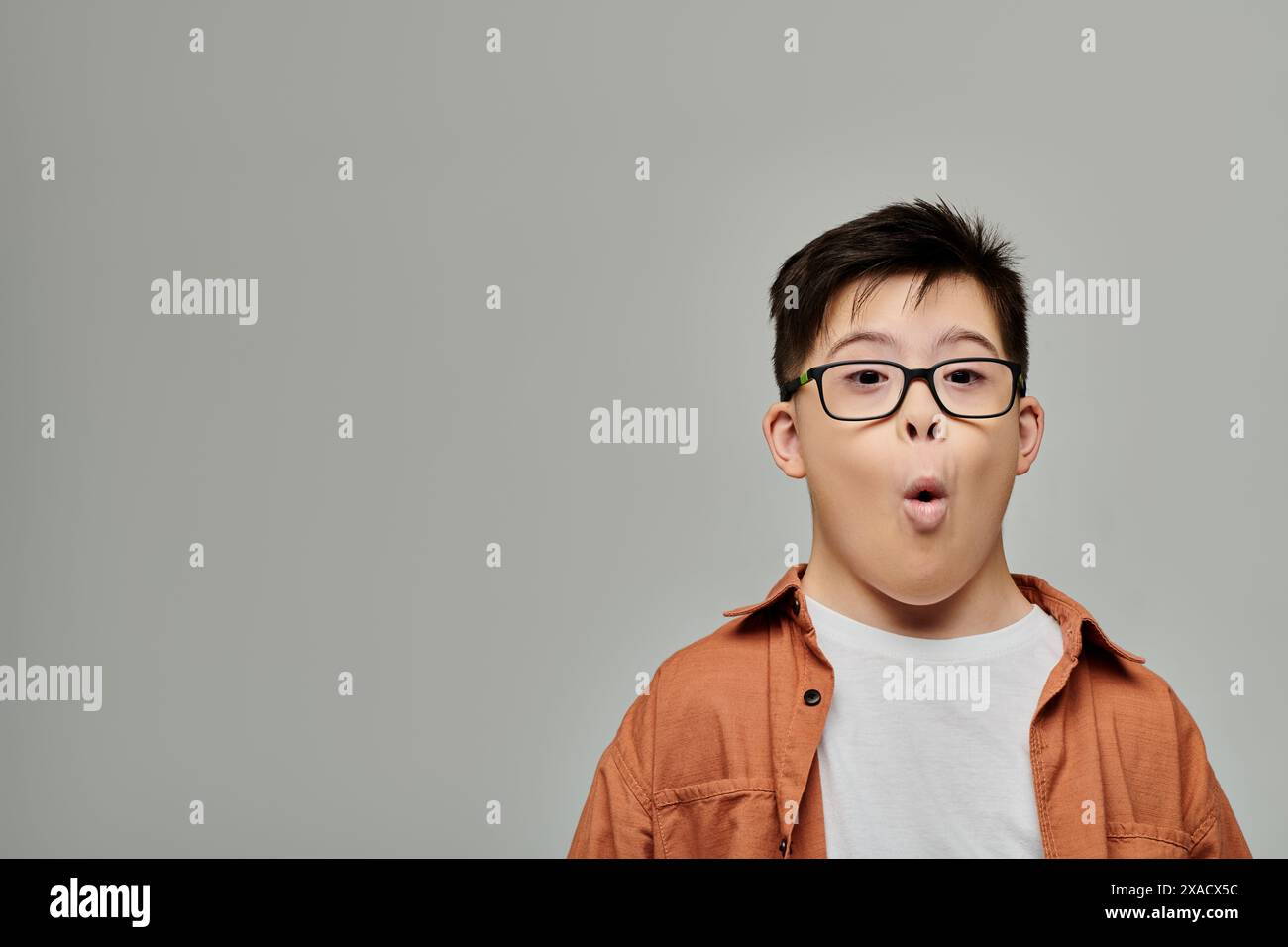 A little boy with Down syndrome makes a silly expression Stock Photo ...