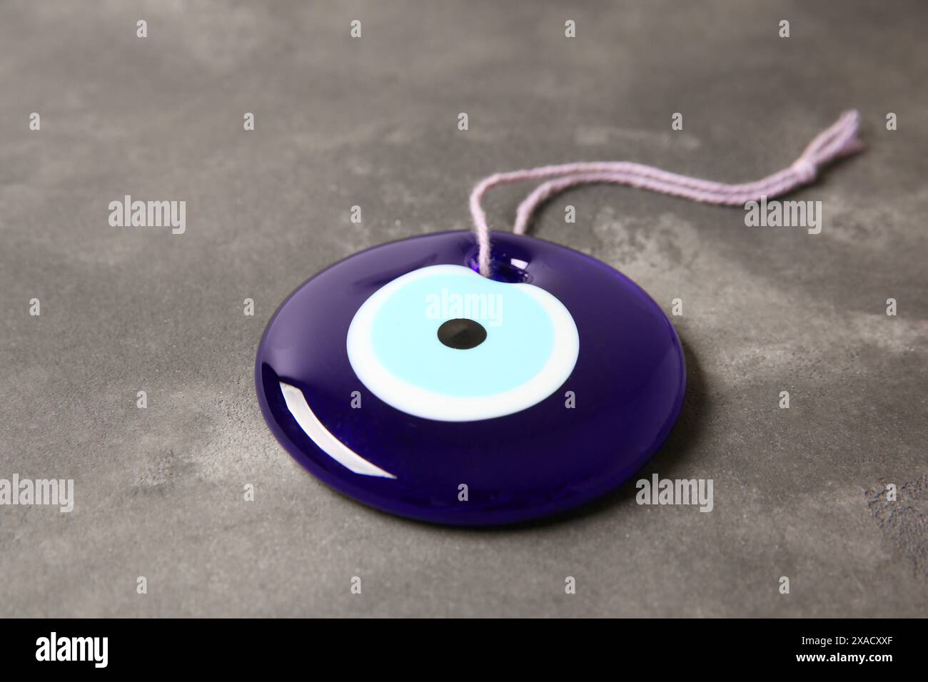 Traditional evil eye amulet on grey table, closeup Stock Photo - Alamy