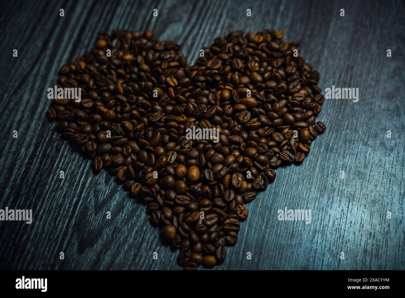 Heart laid out from coffee beans on a wooden table. High quality photo ...