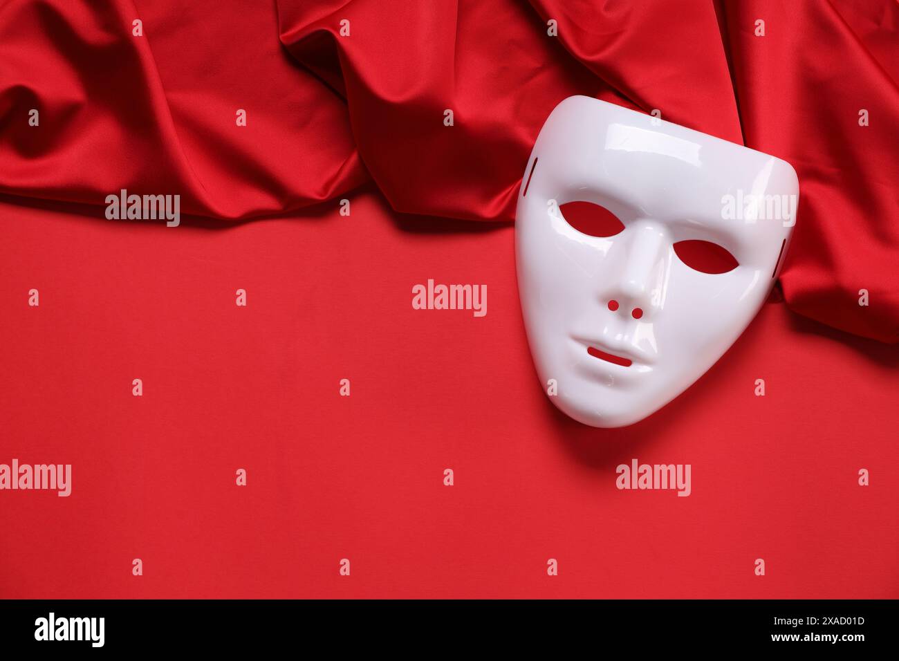 Theater arts. White mask and fabric on red background, top view. Space ...