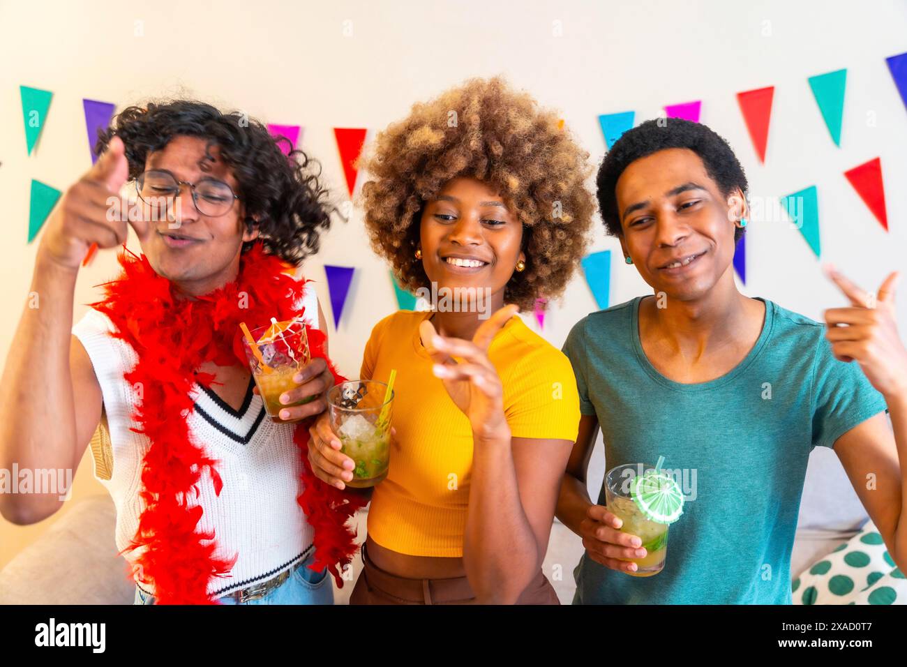 Happy multi-ethnic friends partying and drinking colorful cocktails ...