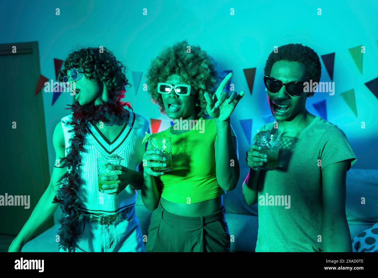 Multi-ethnic young students dancing and drinking alcohol during night ...