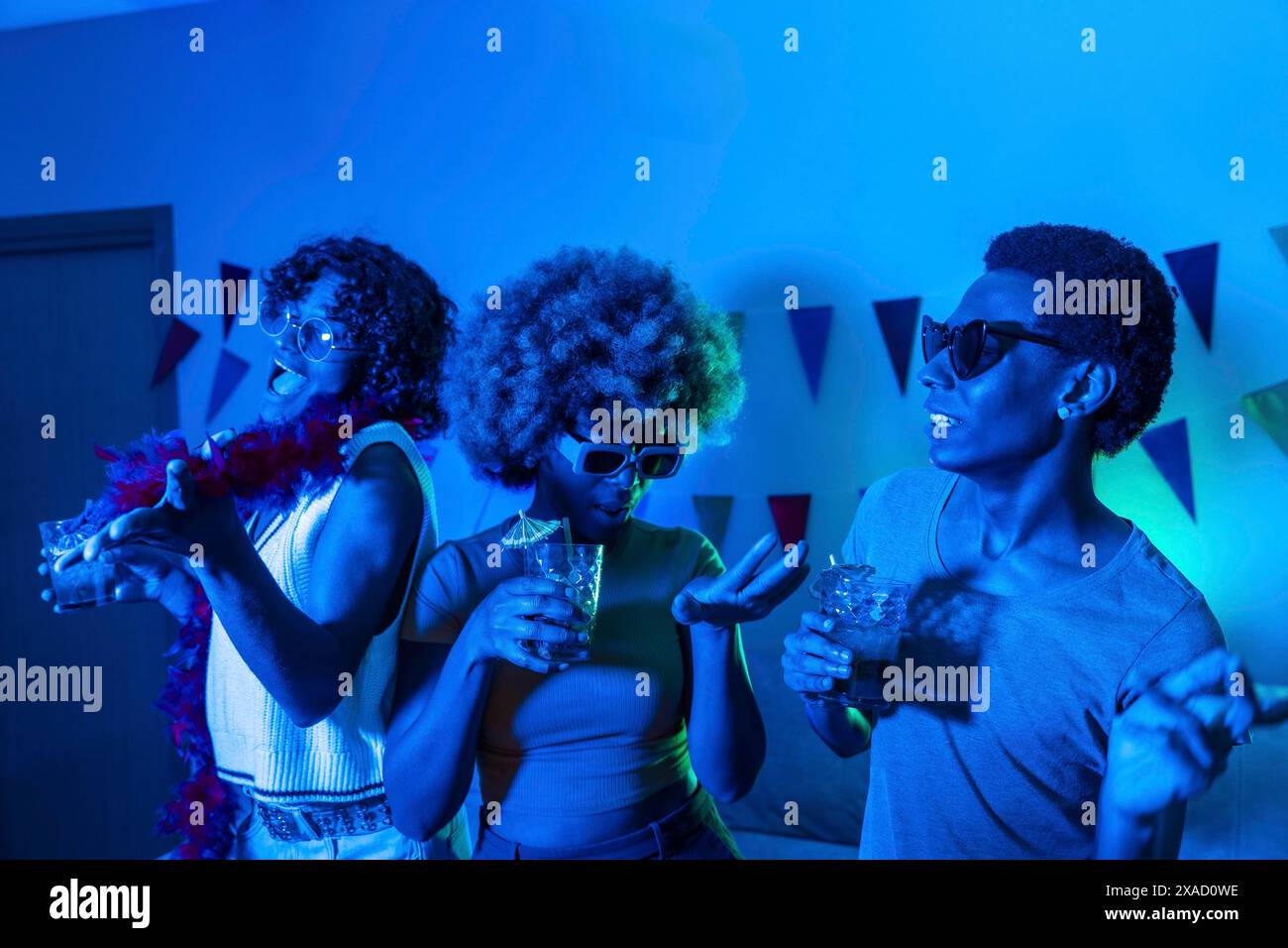 Drunk friends partying and dancing at home at night with colorful neon ...