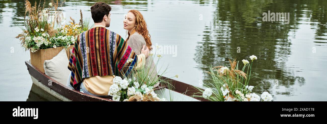 A couple in boho attire peacefully row a boat adorned with flowers in a ...