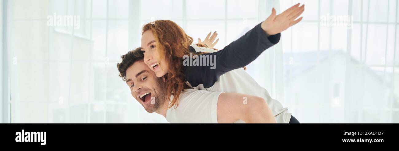 A man supporting a woman on his back, showing strength and unity in ...