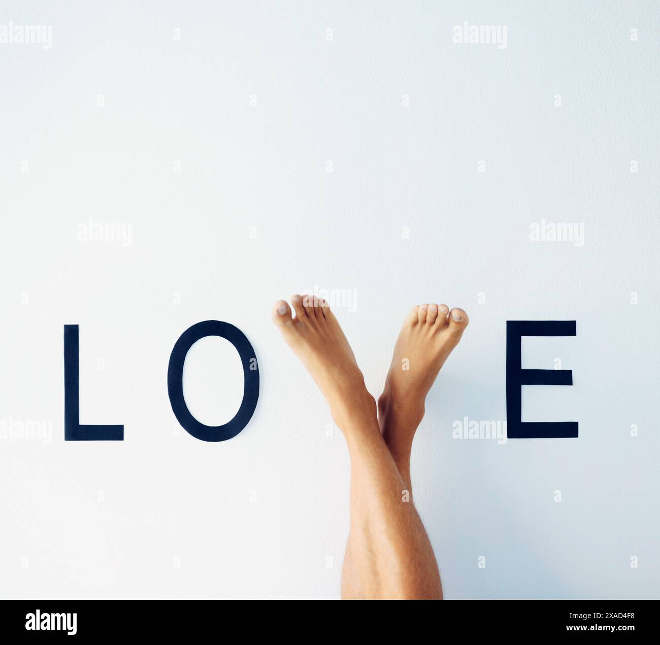 Love, word and feet of person with care, happiness and romance sign of ...