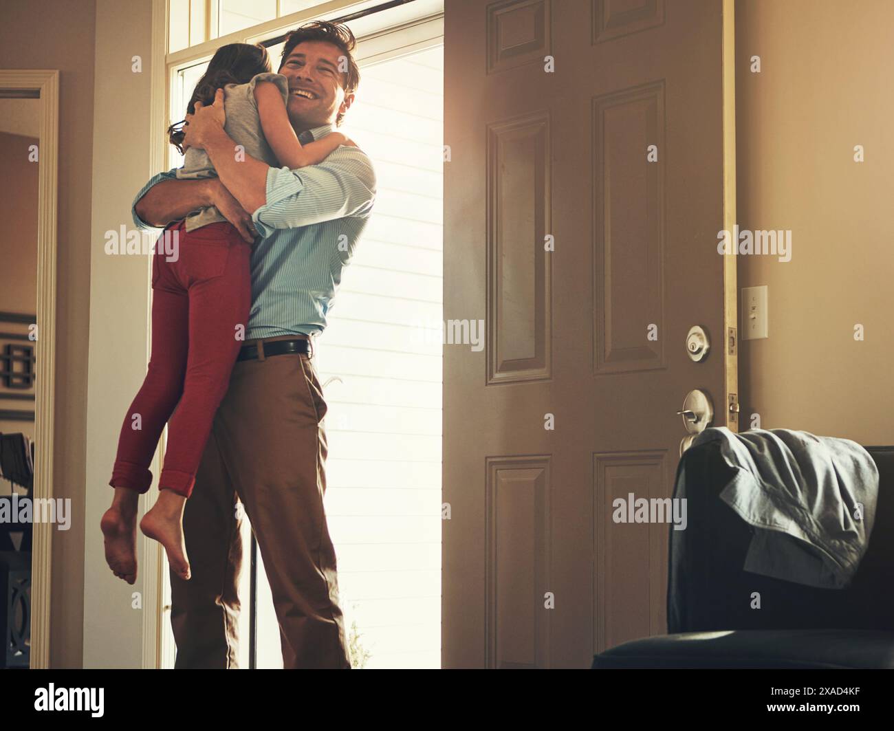 Father, hug and child at door for welcome home, hello and excited ...