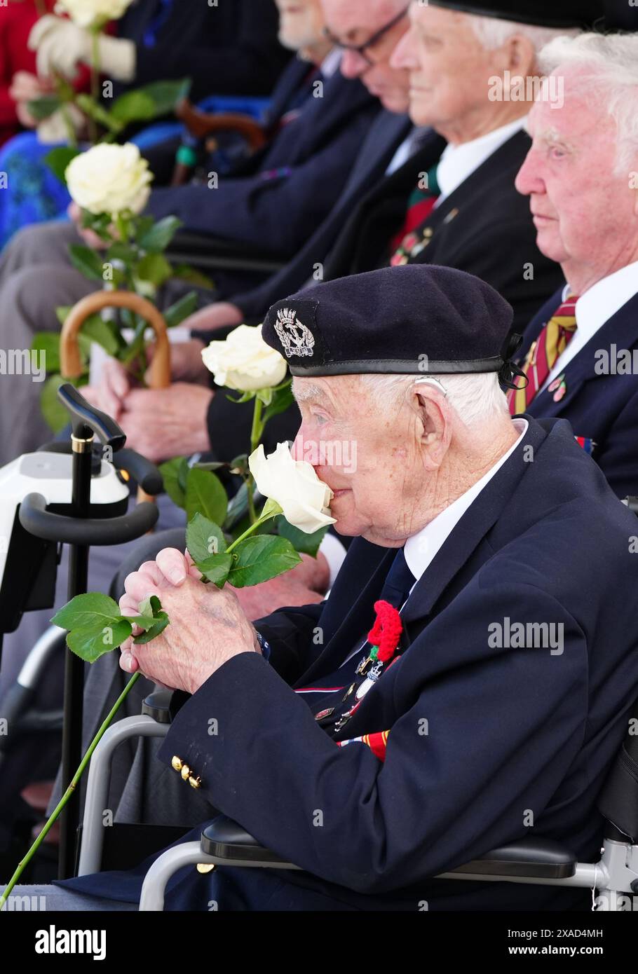 Veterans, inlcuding Henry Rice(front), 98, holding roses which they ...