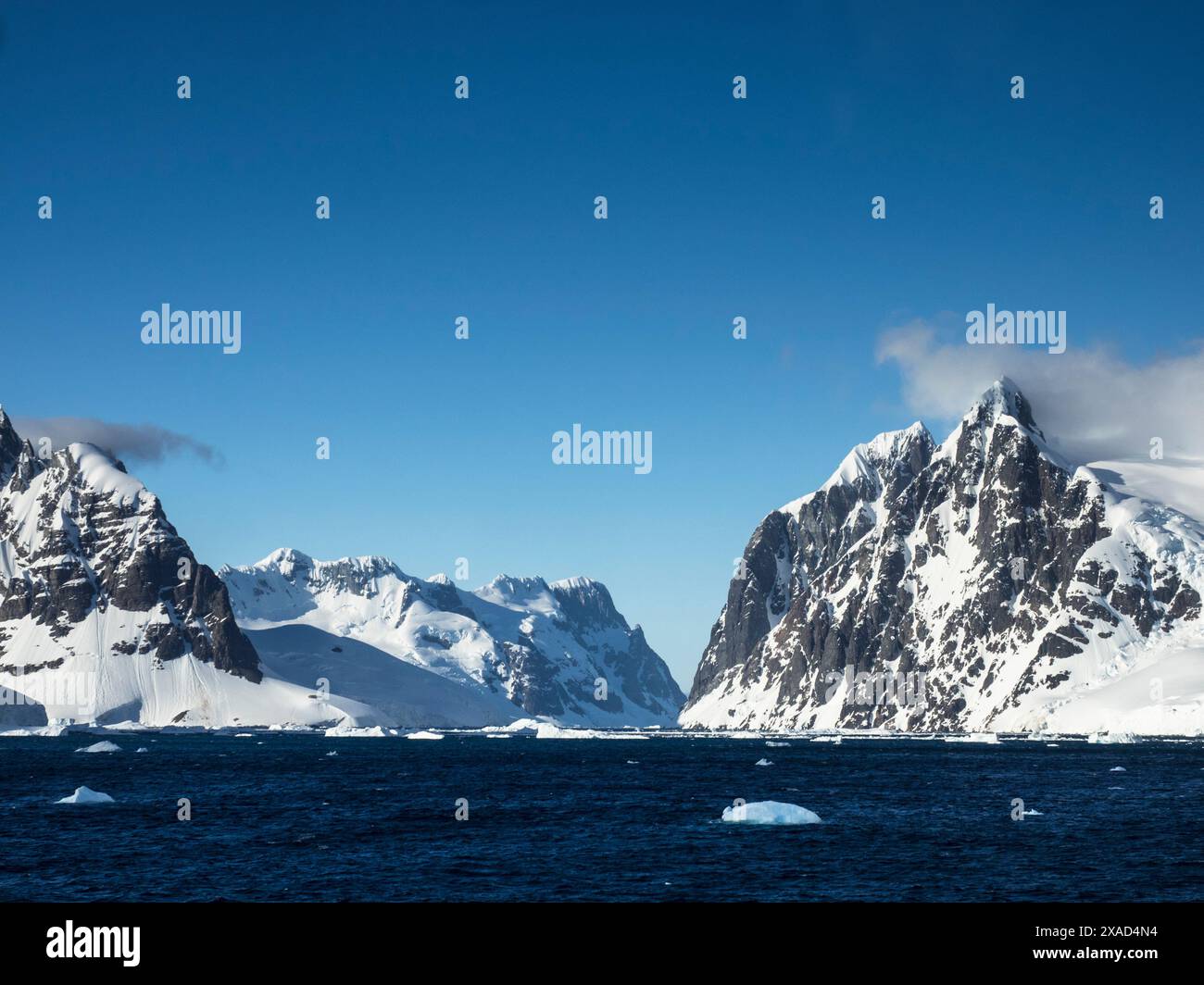 Mt Cloos (l) at the northern entrance to the Lemaire Channel between ...