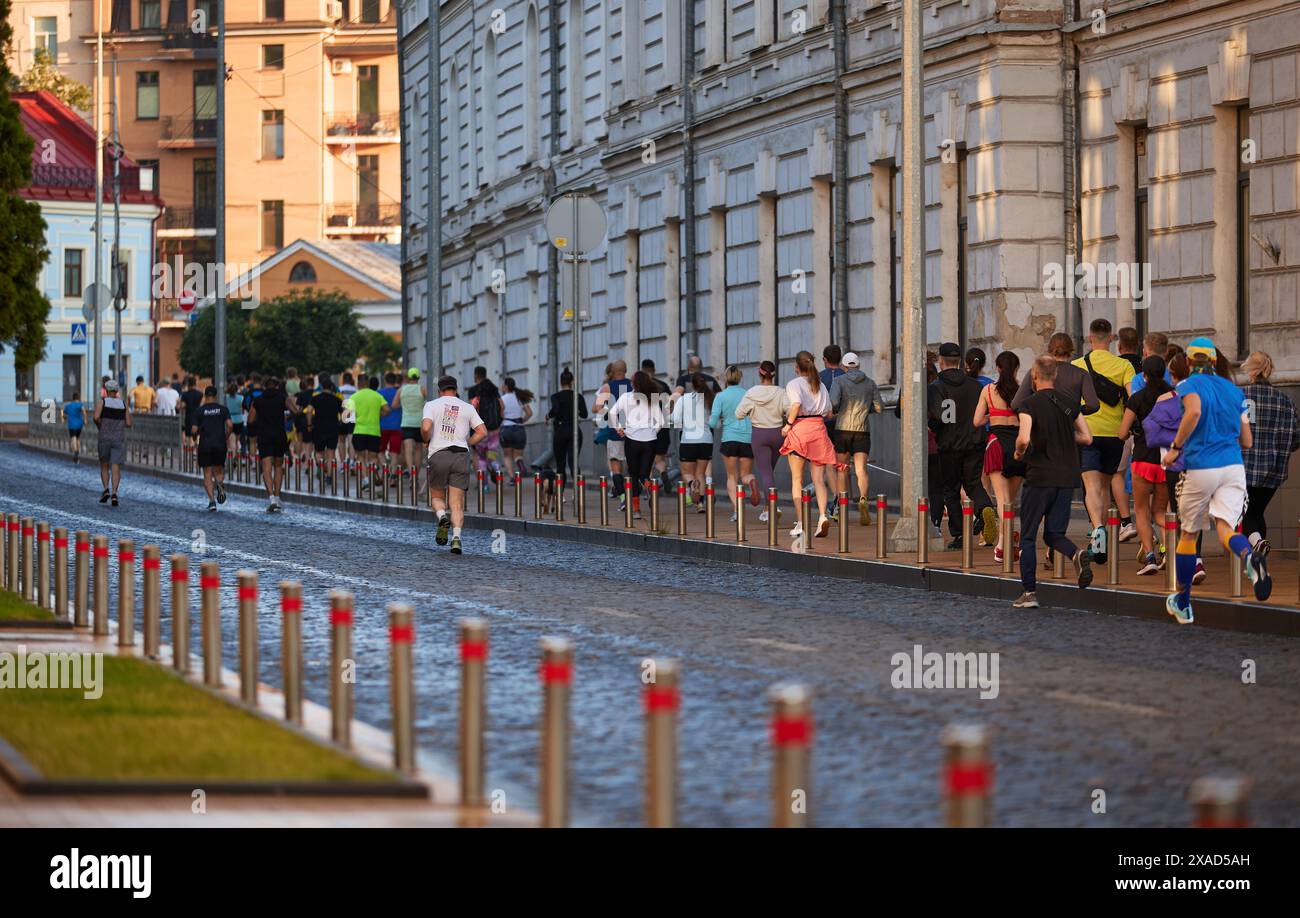 Urban run in Ukraine. Large group of runners running in the streets of ...