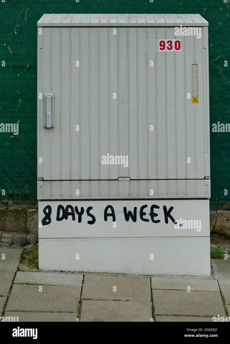 Handwritten black lettering "8 days a week" at a gray electrical ...