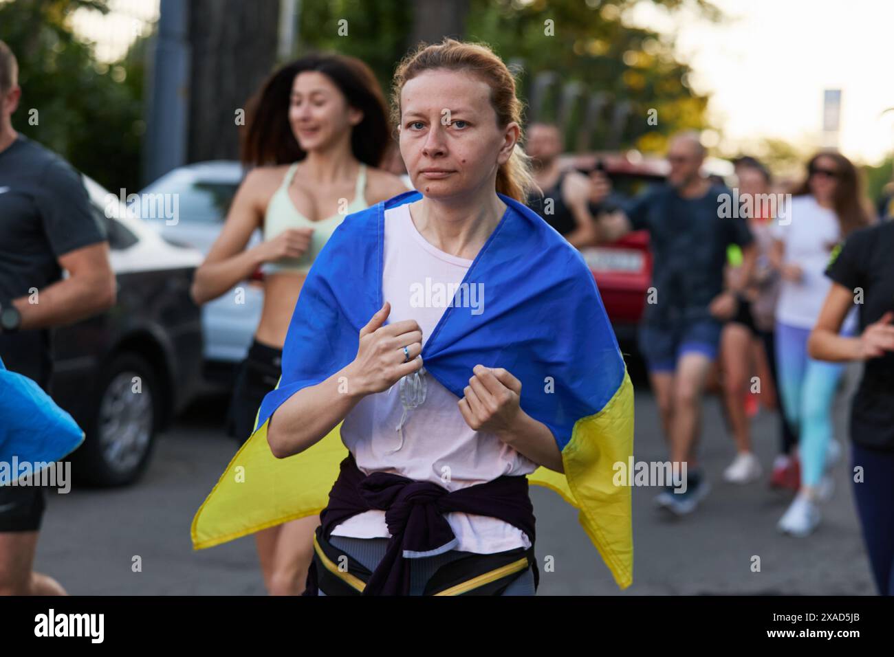 Patriotic Ukrainian woman run with local running community wearing a national yellow and blue ...