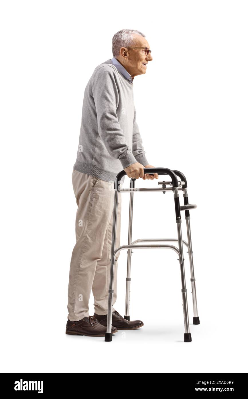 Full length profile shot of an elderly man standing with a walker ...