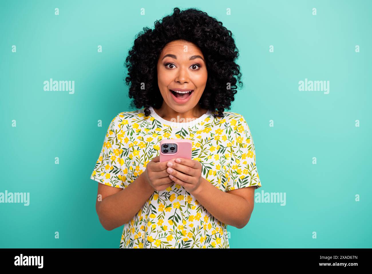 Photo of excited positive woman wear flower t-shirt texting instagram ...