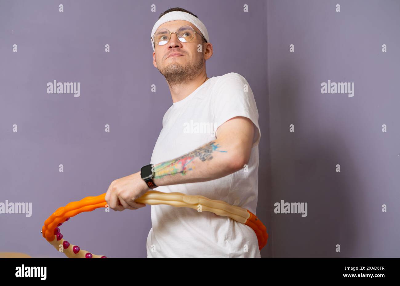 Man In White T-Shirt And Headband Using A Weighted Hula Hoop For ...