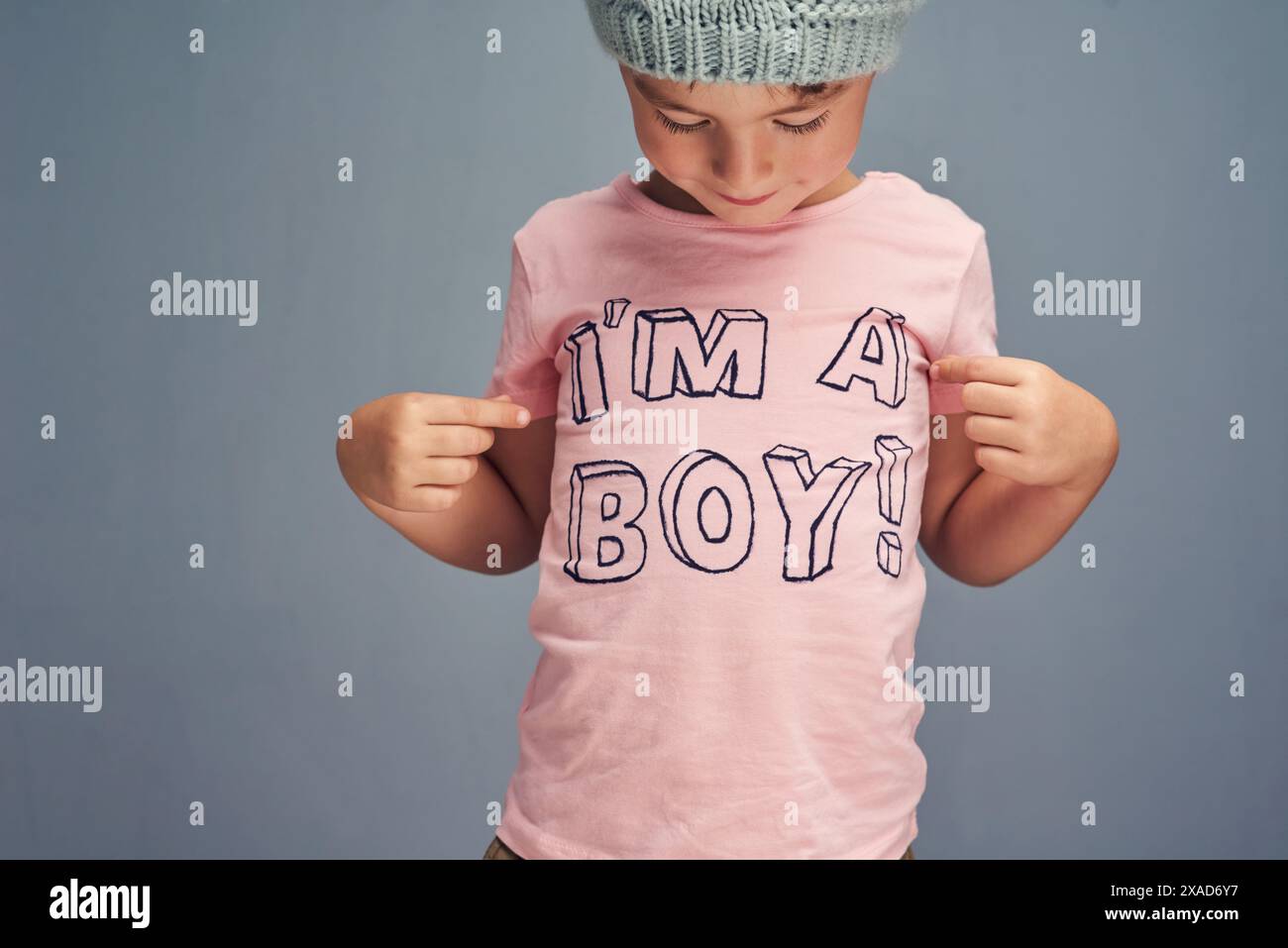 Hands, child and point at print on shirt for gender identity, style and ...
