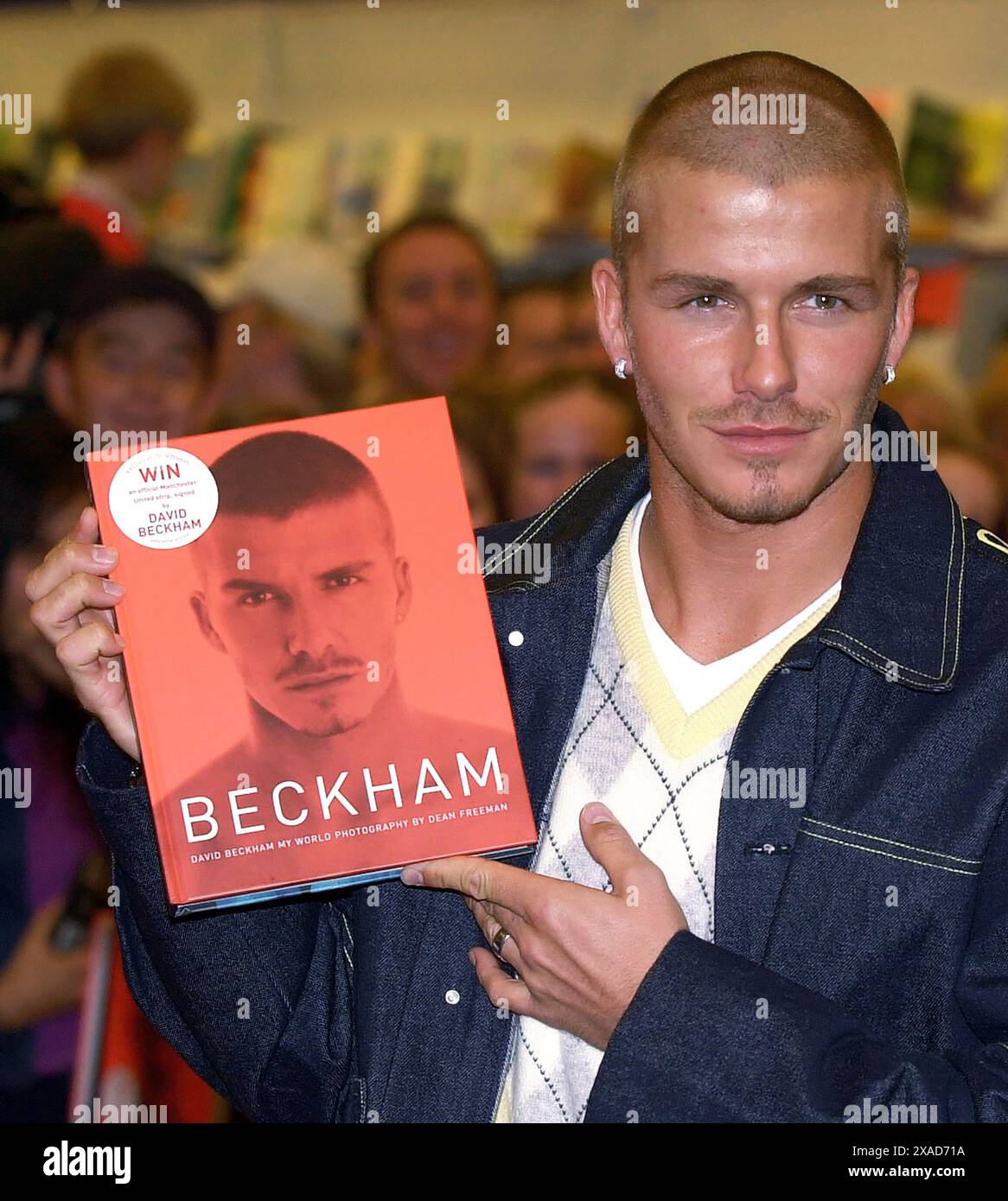 Manchester United and England footballer David Beckham with a copy of ...