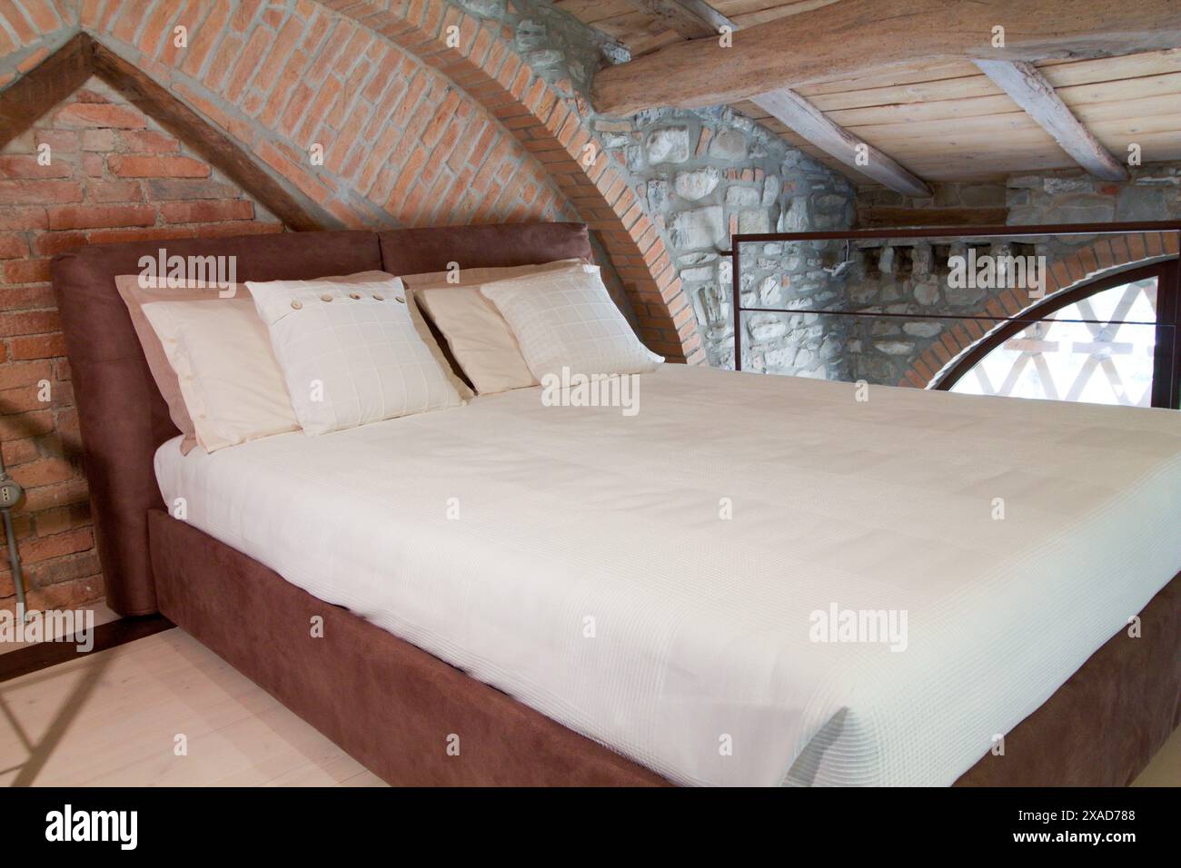 close up of a double bed on a mezzanine in a rustic setting Stock Photo ...