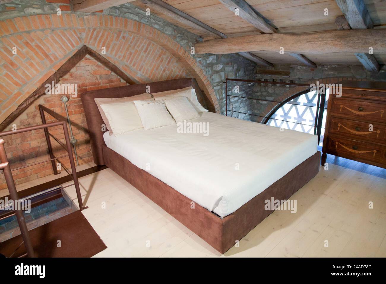 Double bed on a mezzanine in a rustic loft on the hills Stock Photo - Alamy