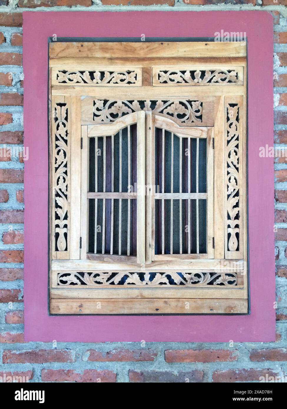 beautiful indonesian window in carved wood on bricks wall Stock Photo ...