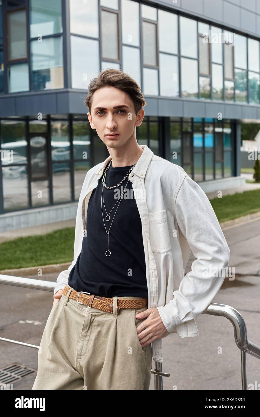 A stylishly dressed young man striking a pose in front of a ...