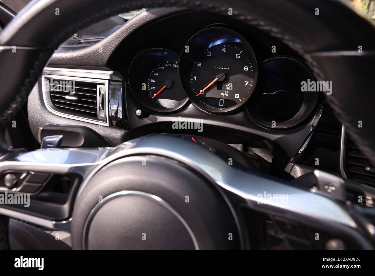 Steering wheel, speedometer and tachometer inside of modern car ...