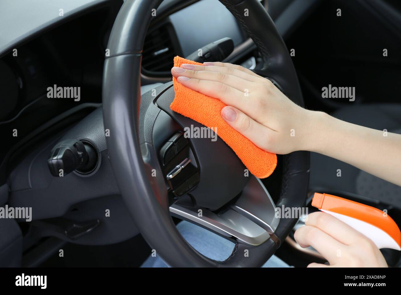 Woman cleaning steering wheel with rag in car, closeup Stock Photo - Alamy