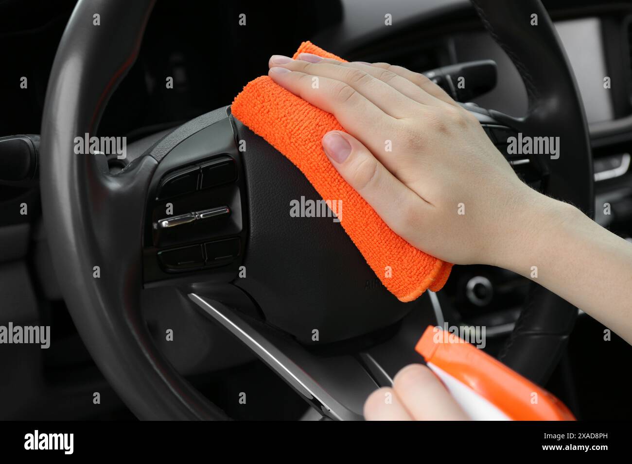 Woman cleaning steering wheel with rag in car, closeup Stock Photo - Alamy