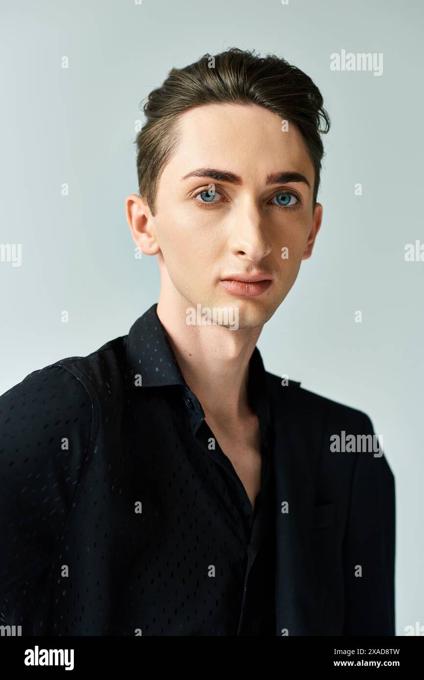 A vibrant, queer person in a black shirt strikes a confident pose in a ...