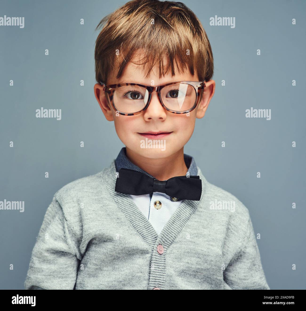 Fashion, glasses and portrait of boy geek in studio isolated on blue ...