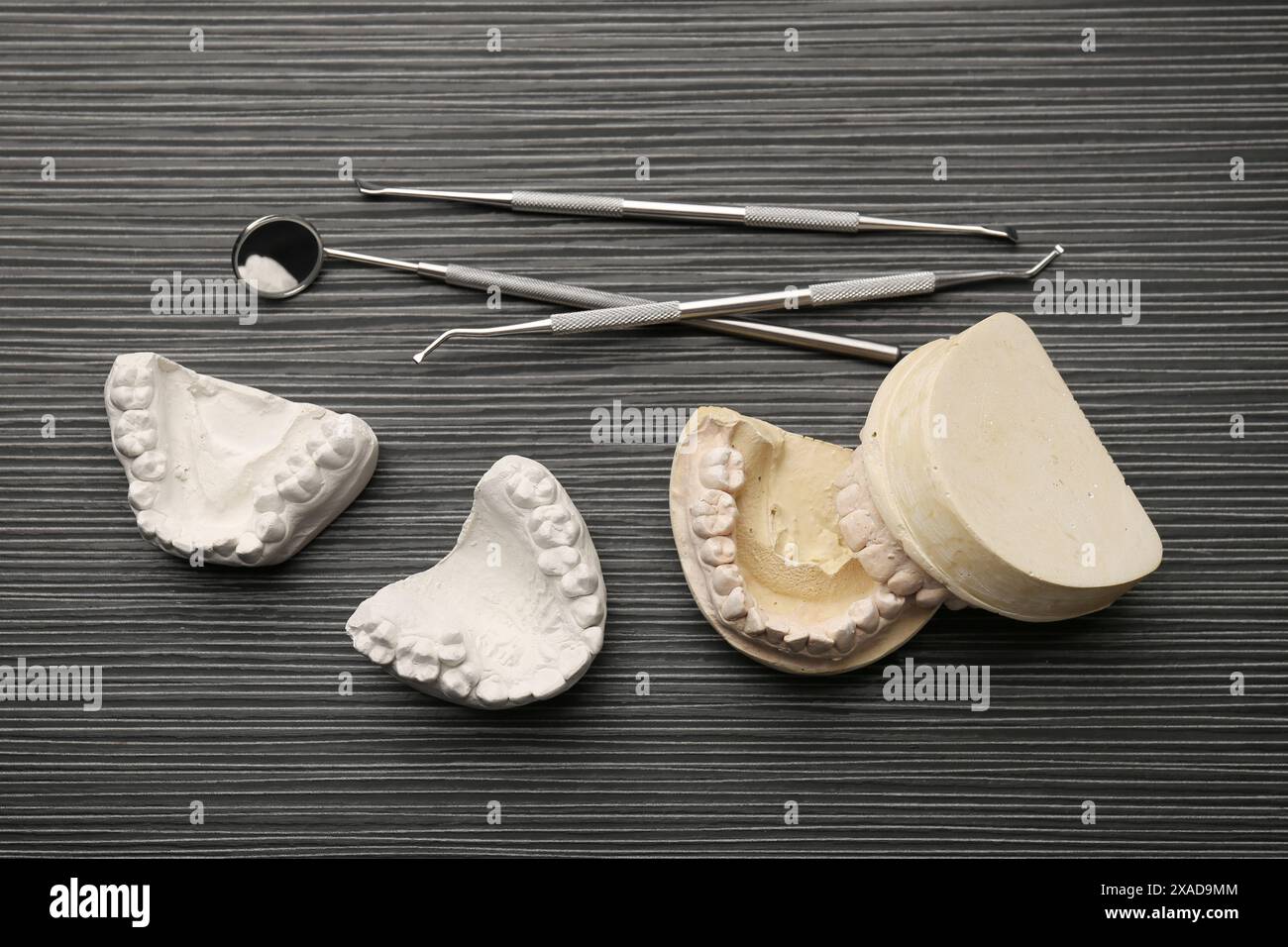 Dental models with gums and dentist tools on grey wooden table, flat ...