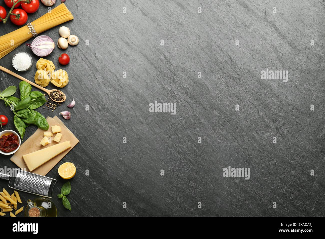 Different types of pasta, spices, garter and products on dark textured ...