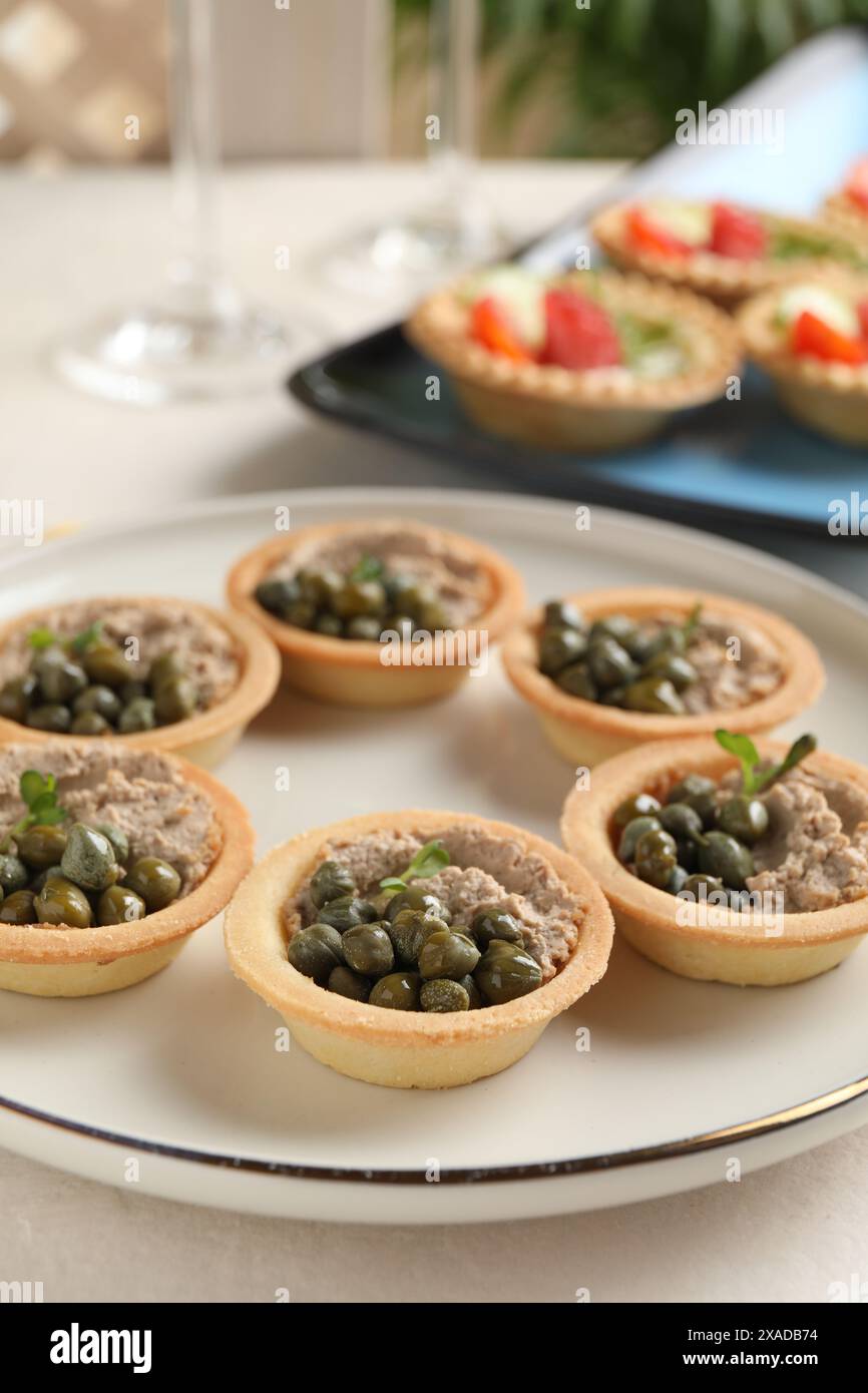 Delicious canapes with pate and capers on white table, closeup Stock ...