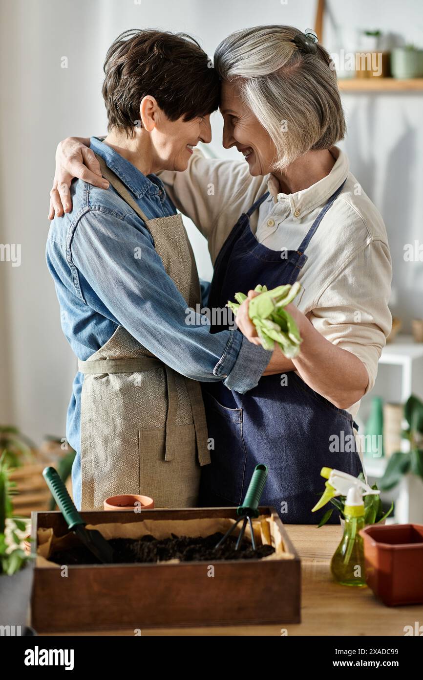 Two mature women friends hugging hi-res stock photography and images ...
