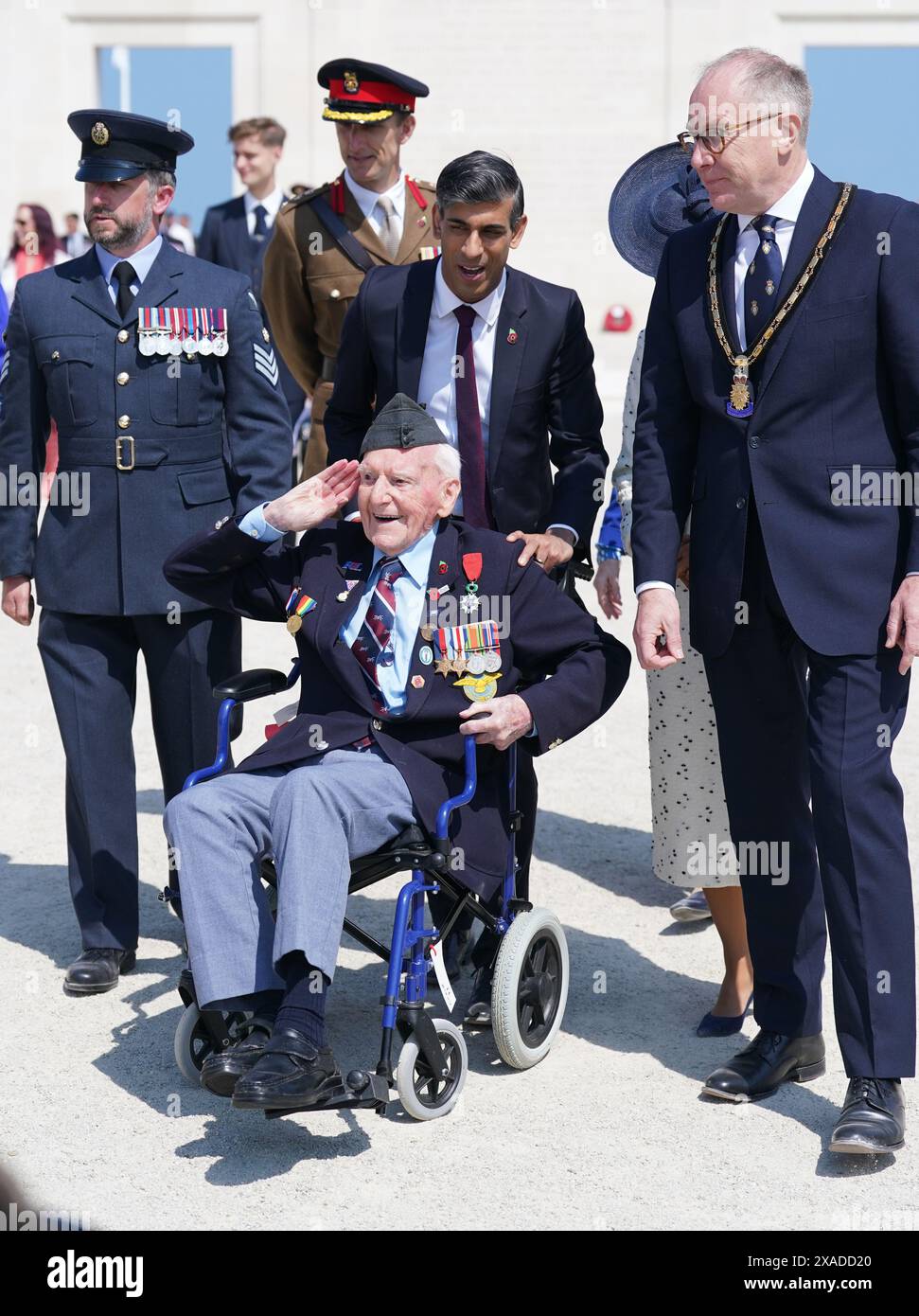 Prime Minister Rishi Sunak wheels a D-Day veteran Bernard Morgan, 100 ...