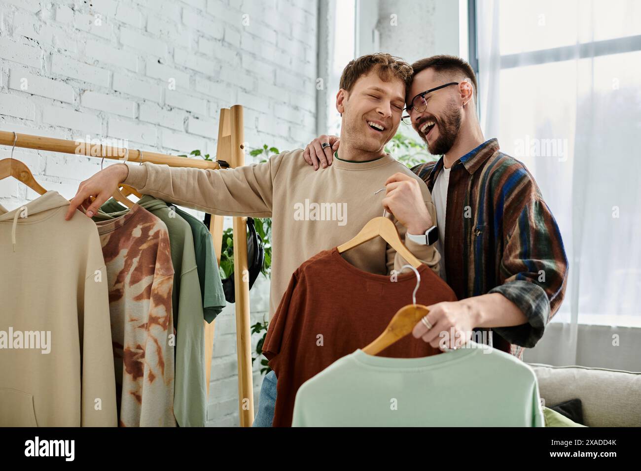 A gay couple in a designer workshop, collaborating on trendy attire Stock Photo - Alamy