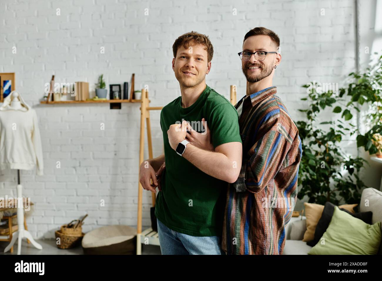 Two men stand in a designer workshop, collaborating on trendy attire ...