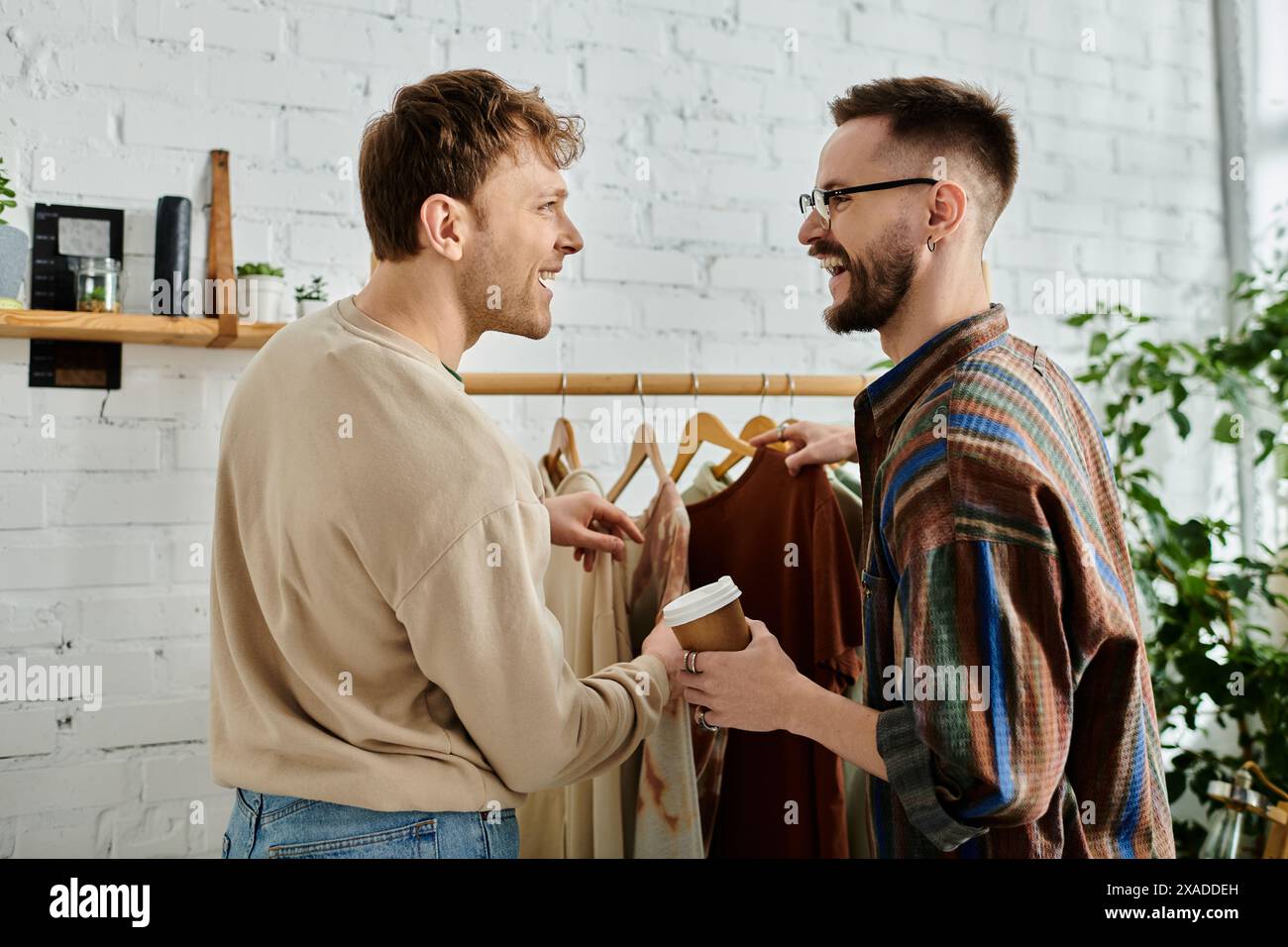 Two male fashion designers collaborate on stylish clothing in a ...