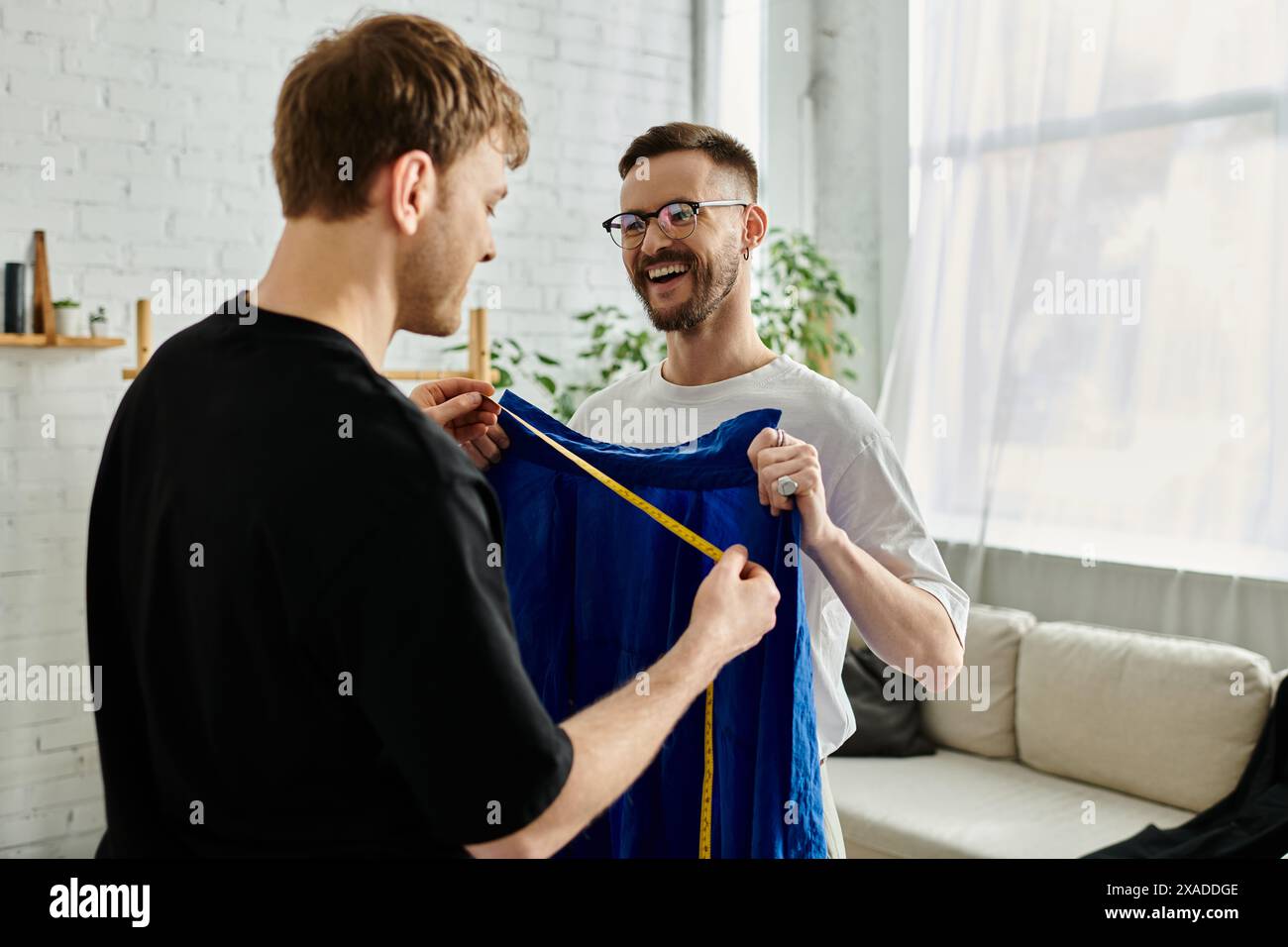 gay couple collaborate in a designer workshop, crafting trendy attire in harmony Stock Photo - Alamy