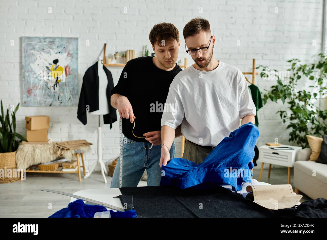 Two men in designer workshop, collaborating on trendy attire Stock ...