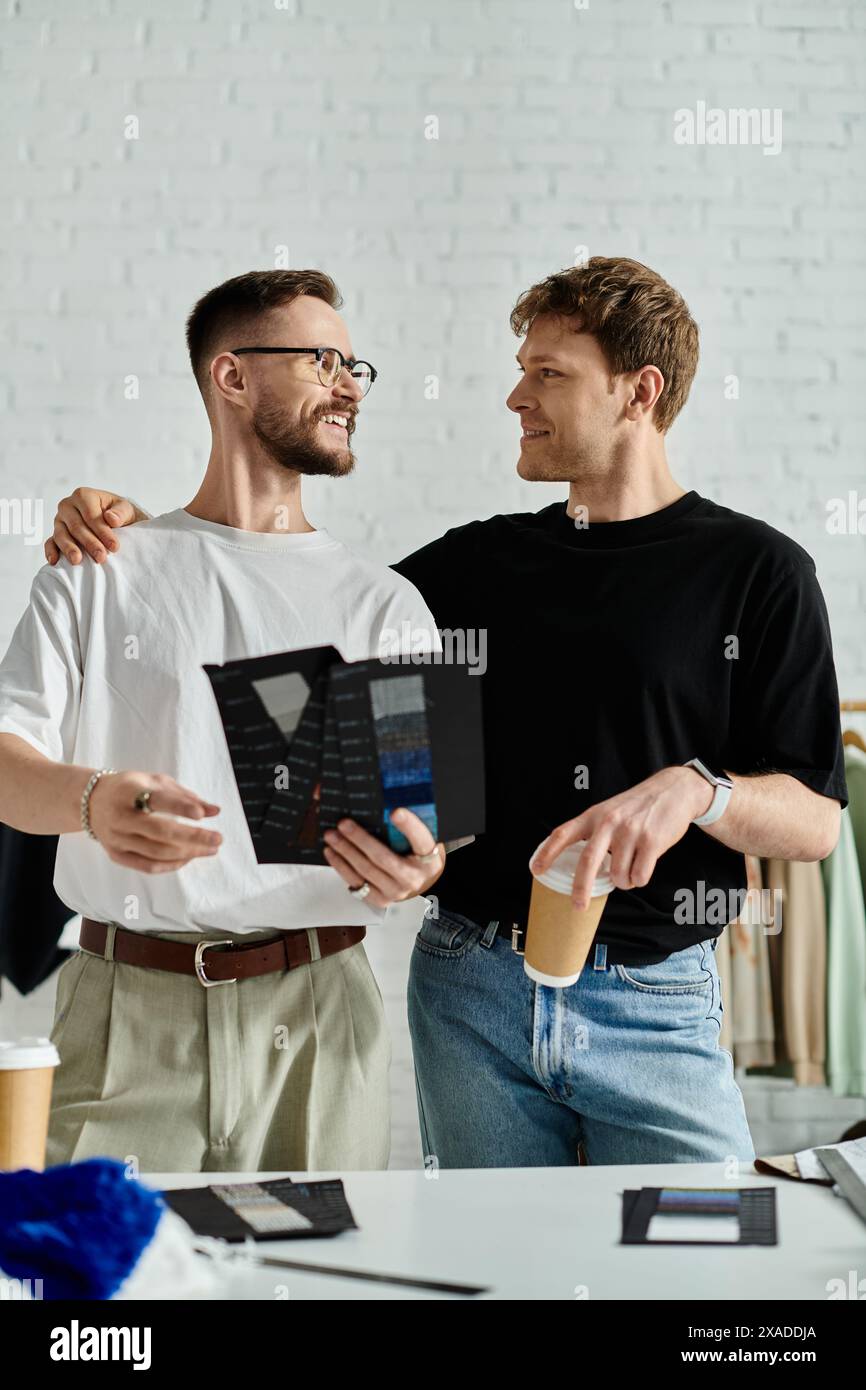 Two men collaborate on designing trendy attire in their atelier Stock ...