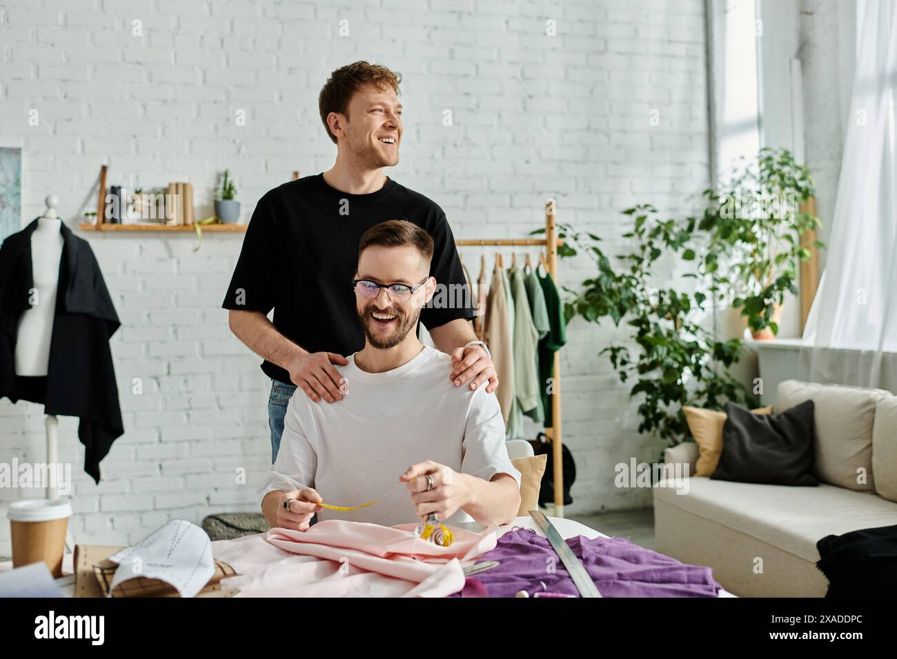 Two men collaborate on a stylish project in their designer workshop ...