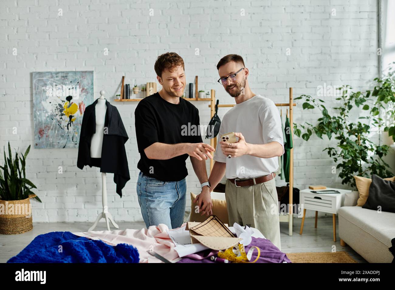 Two designers collaborate on a digital device, sharing ideas for trendy ...