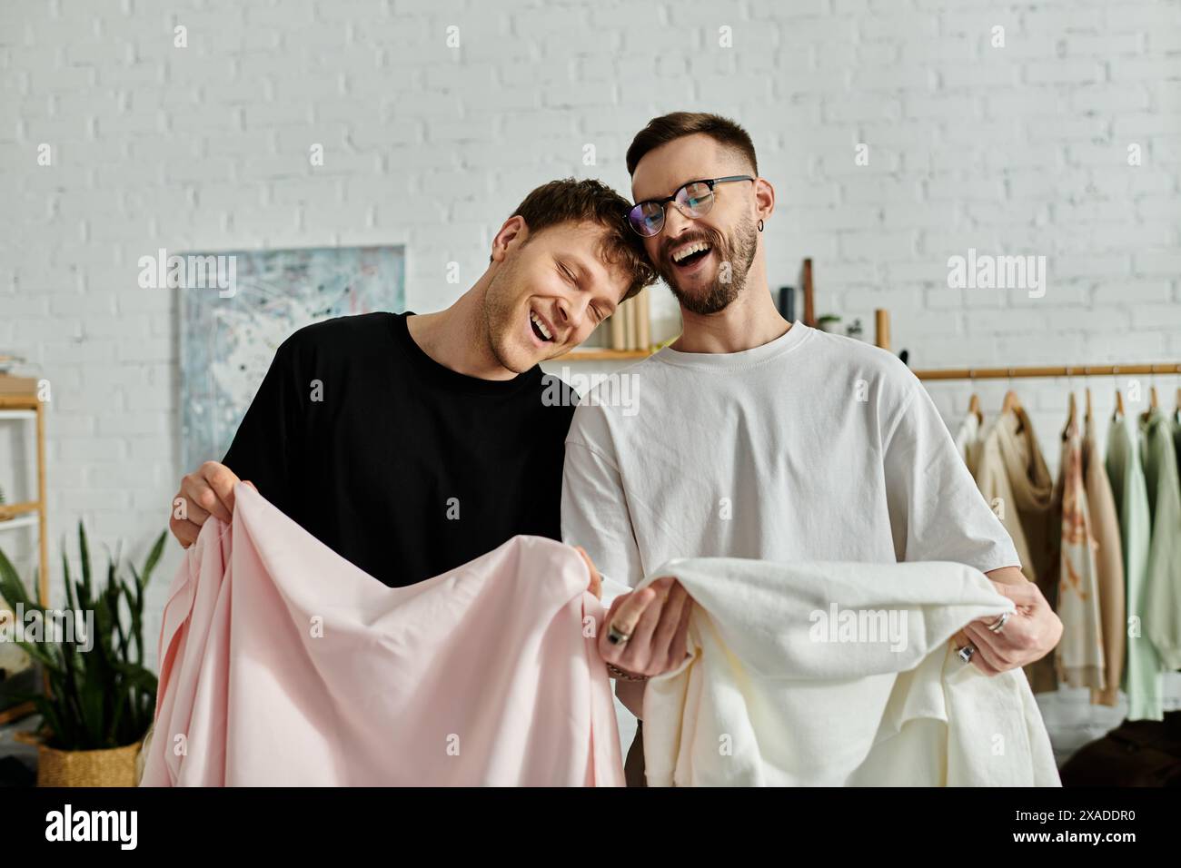 Two men, both fashion designers, standing together in a stylish ...