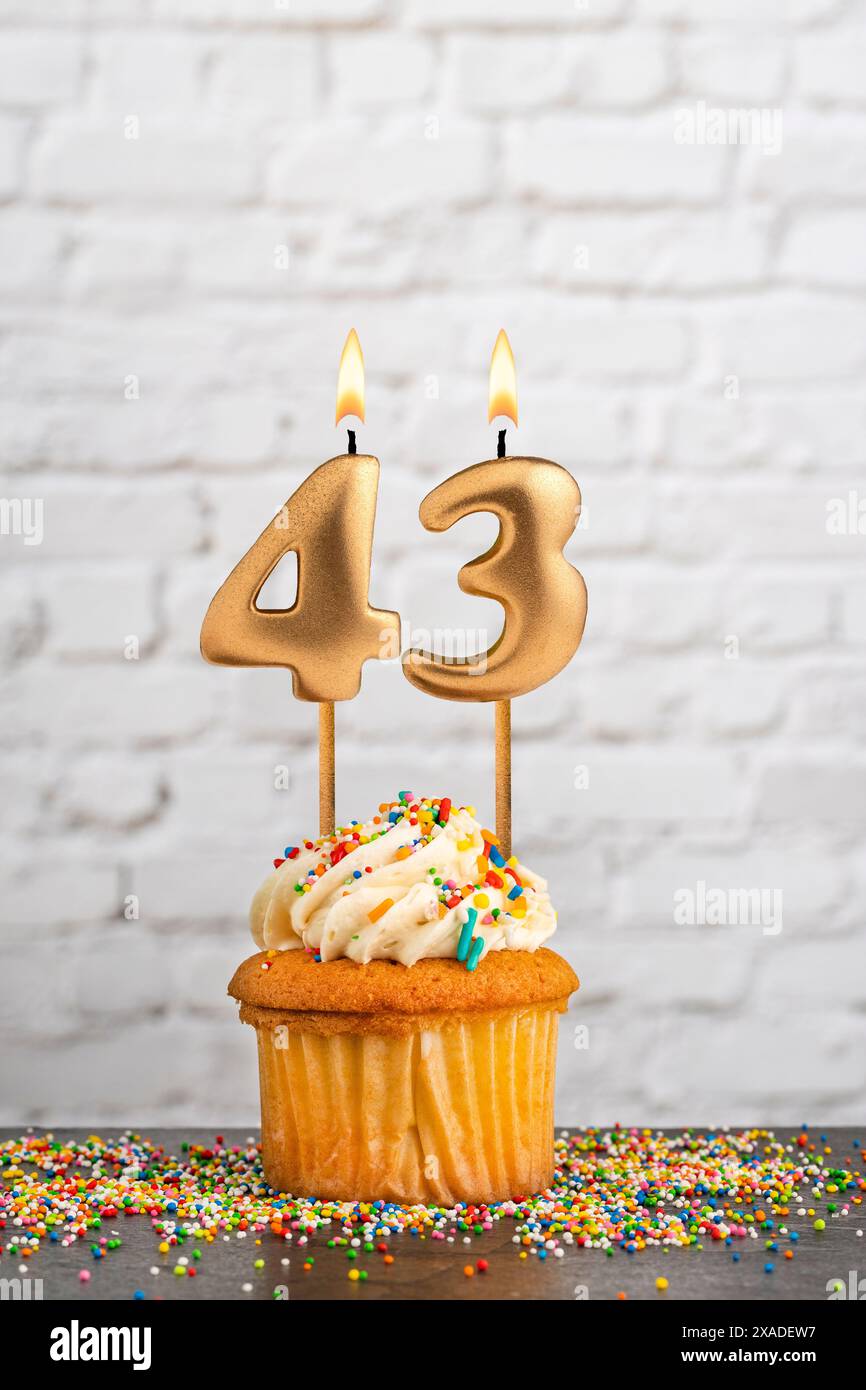 Golden birthday candle number 43 with cupcake - White block wall ...