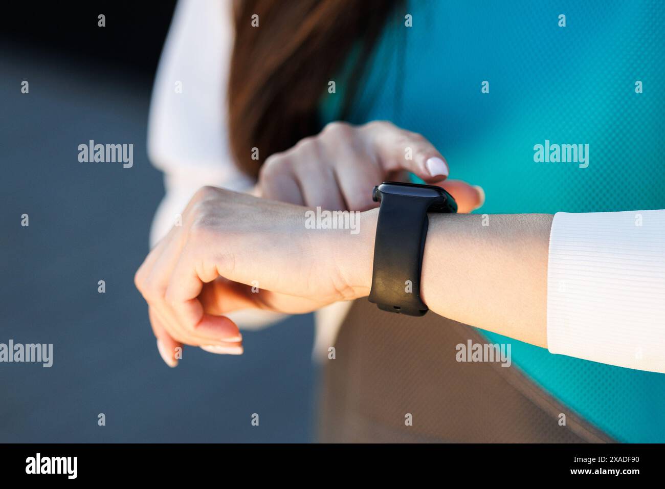 Woman uses a smart watch to measure the pulse on the hands. A woman ...