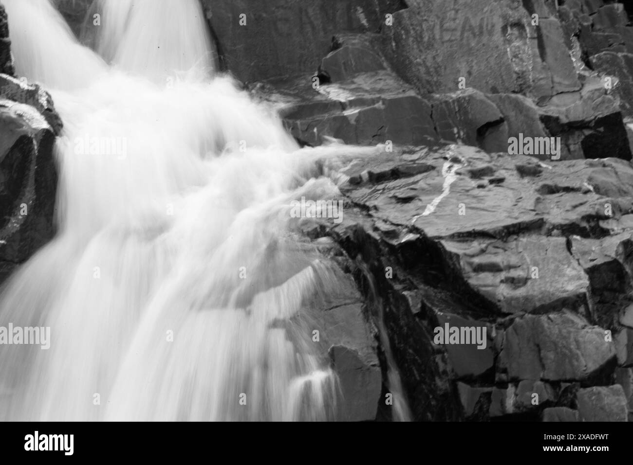 Abstract motion blur of water falling over rock formations at Great ...