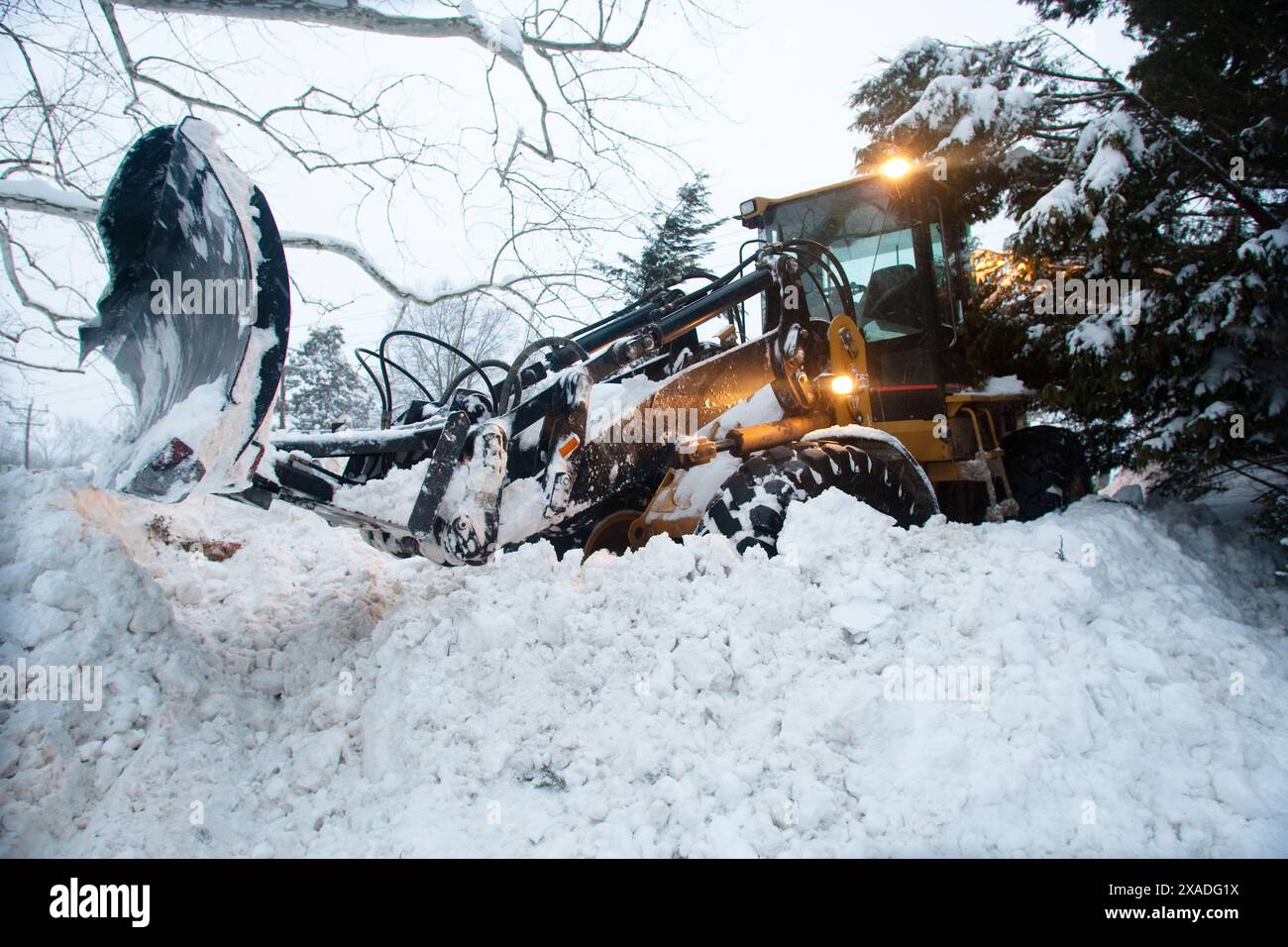 Heavy construction equipment clearing snow on MacArthur Boulevard near ...