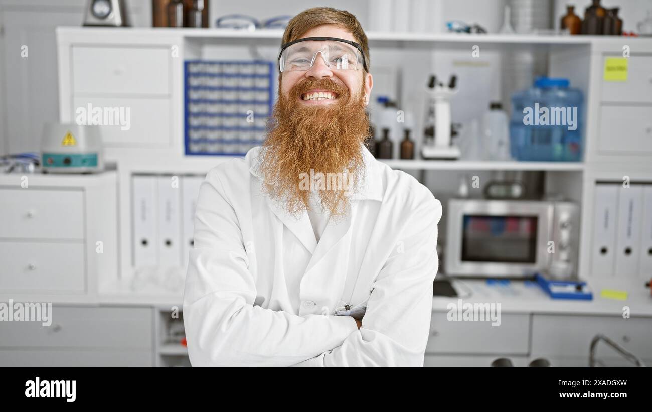 Confident young redhead male scientist with arms crossed in a high ...